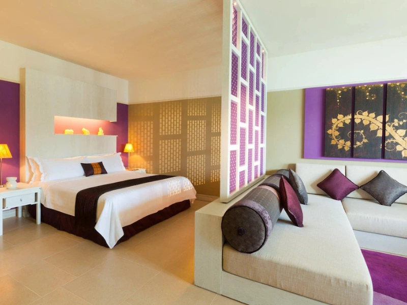 A modern, well-decorated bedroom with a large bed and a comfortable ...